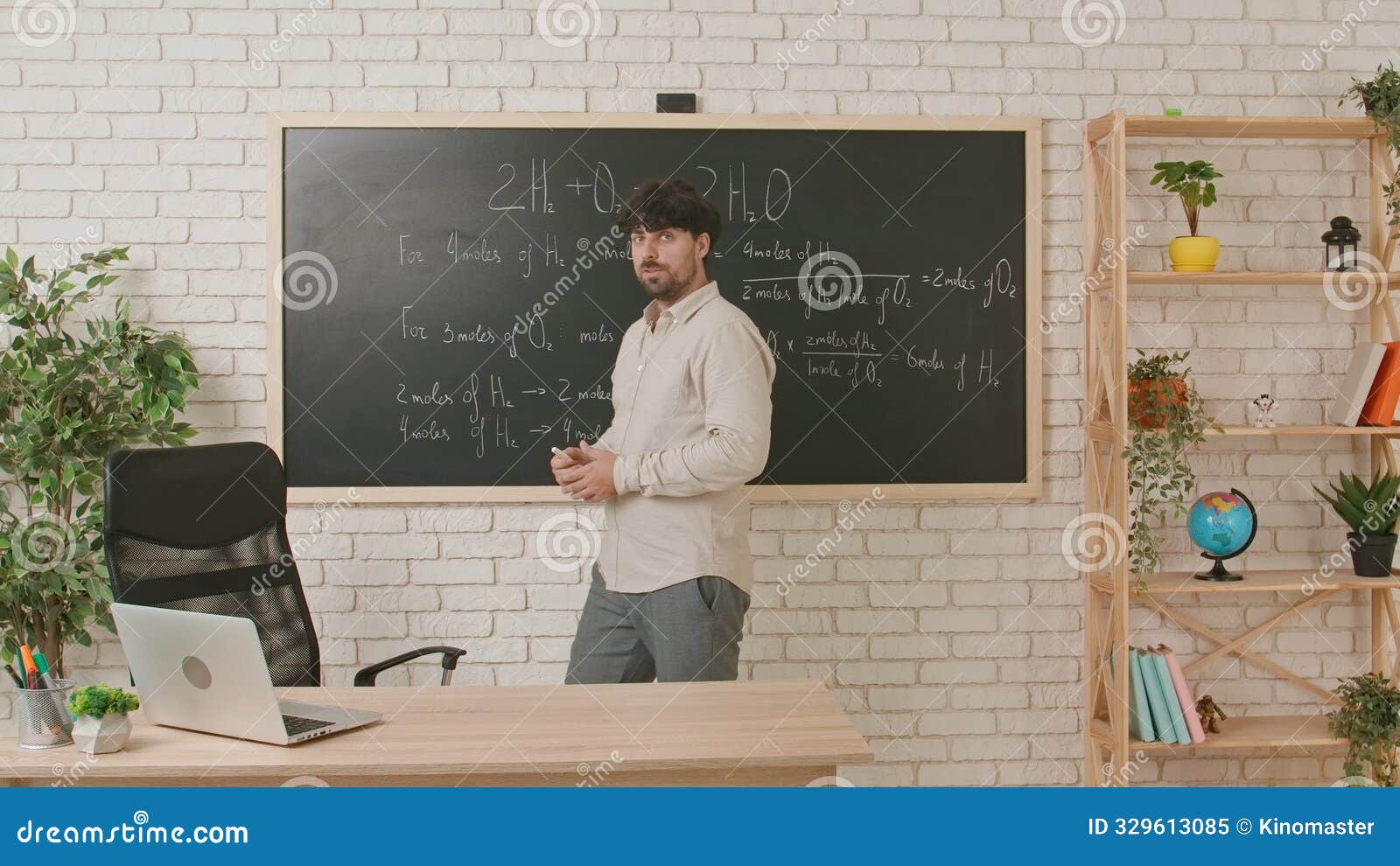 A Male Teacher is Teaching a Chemistry Class and Explaining a Task ...