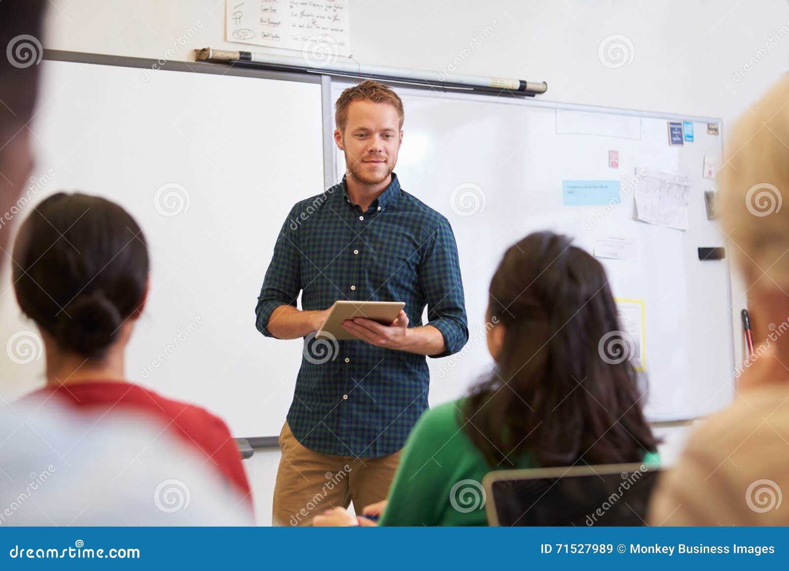 Male Teacher Using Tablet Computer at Adult Education Class Stock Image ...