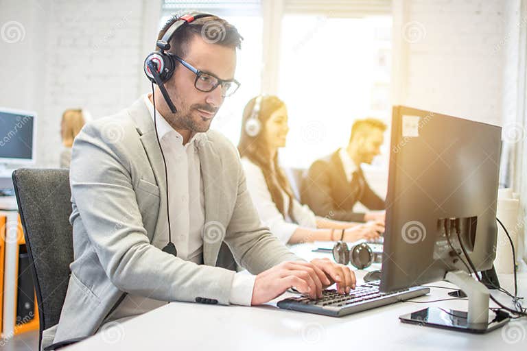 Male Technical Support Service Operator Wearing Headset Working on ...