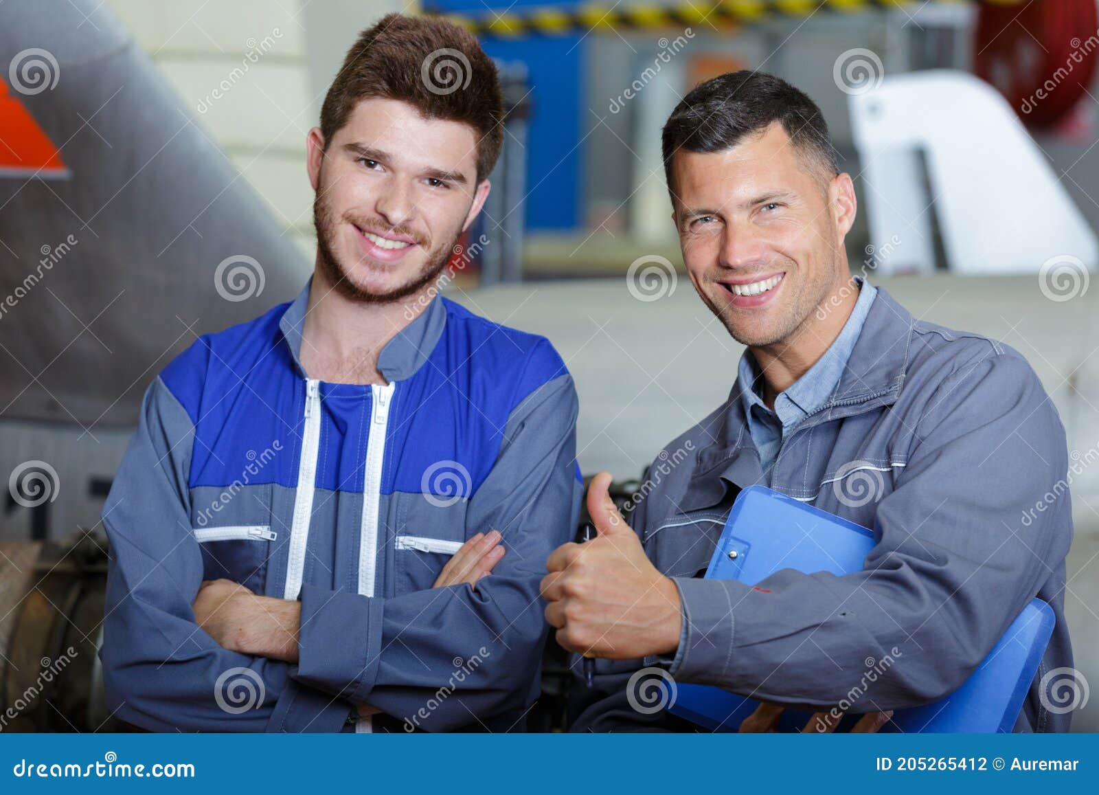 Male Technician and Apprentice Looking at Camera Stock Photo - Image of ...
