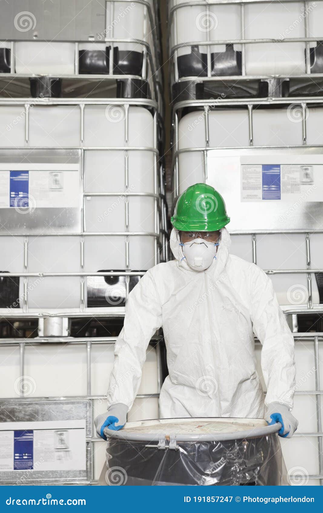 Male Technician in Hazmat Suit Taking Down Notes of Chemical in Drum ...
