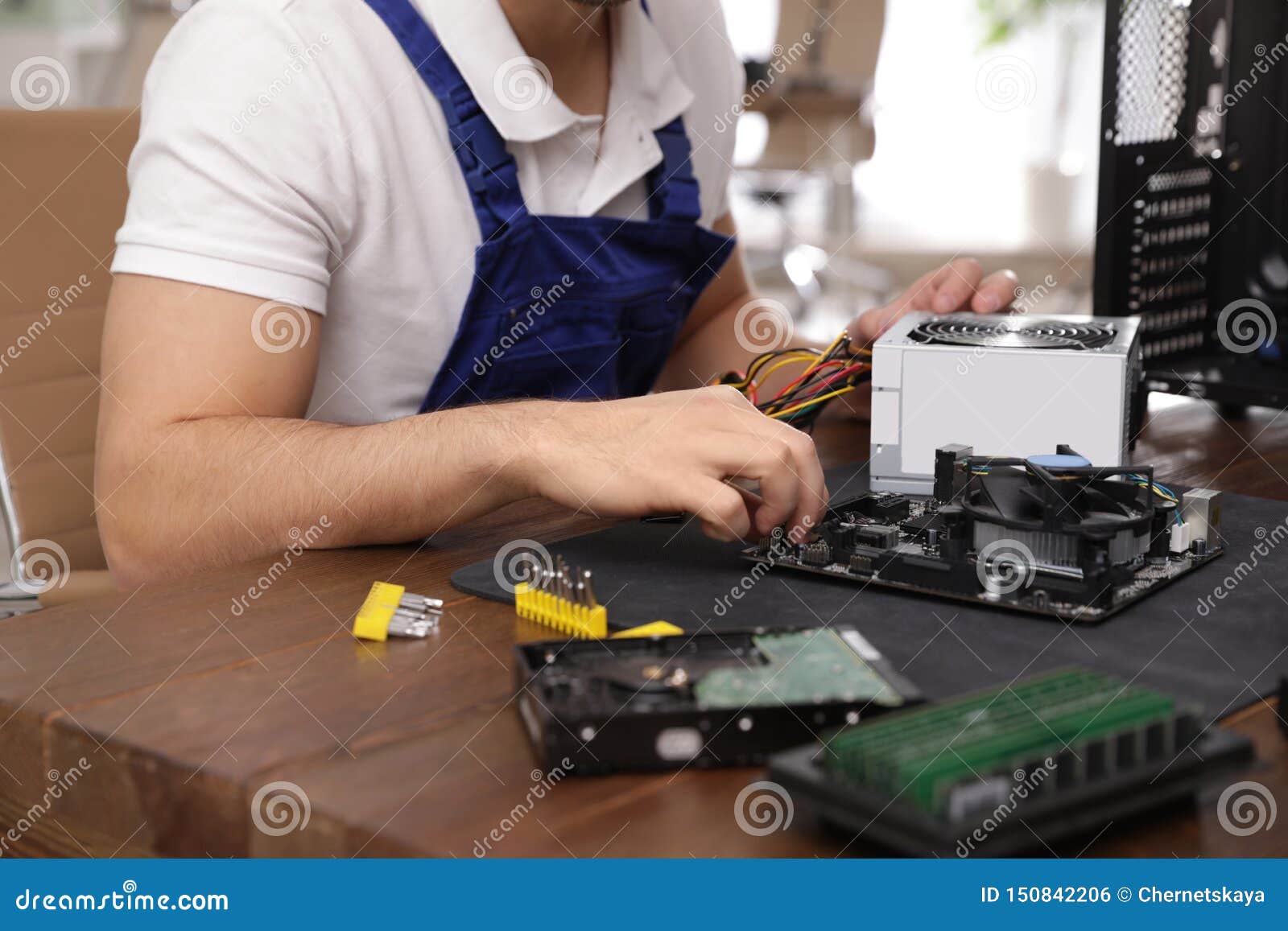 Male Technician Repairing Computer at Table Indoors Stock Photo - Image ...