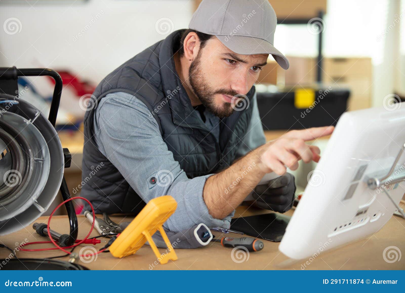 Male Technician Using Voltage Meter and Pc Stock Photo - Image of ...