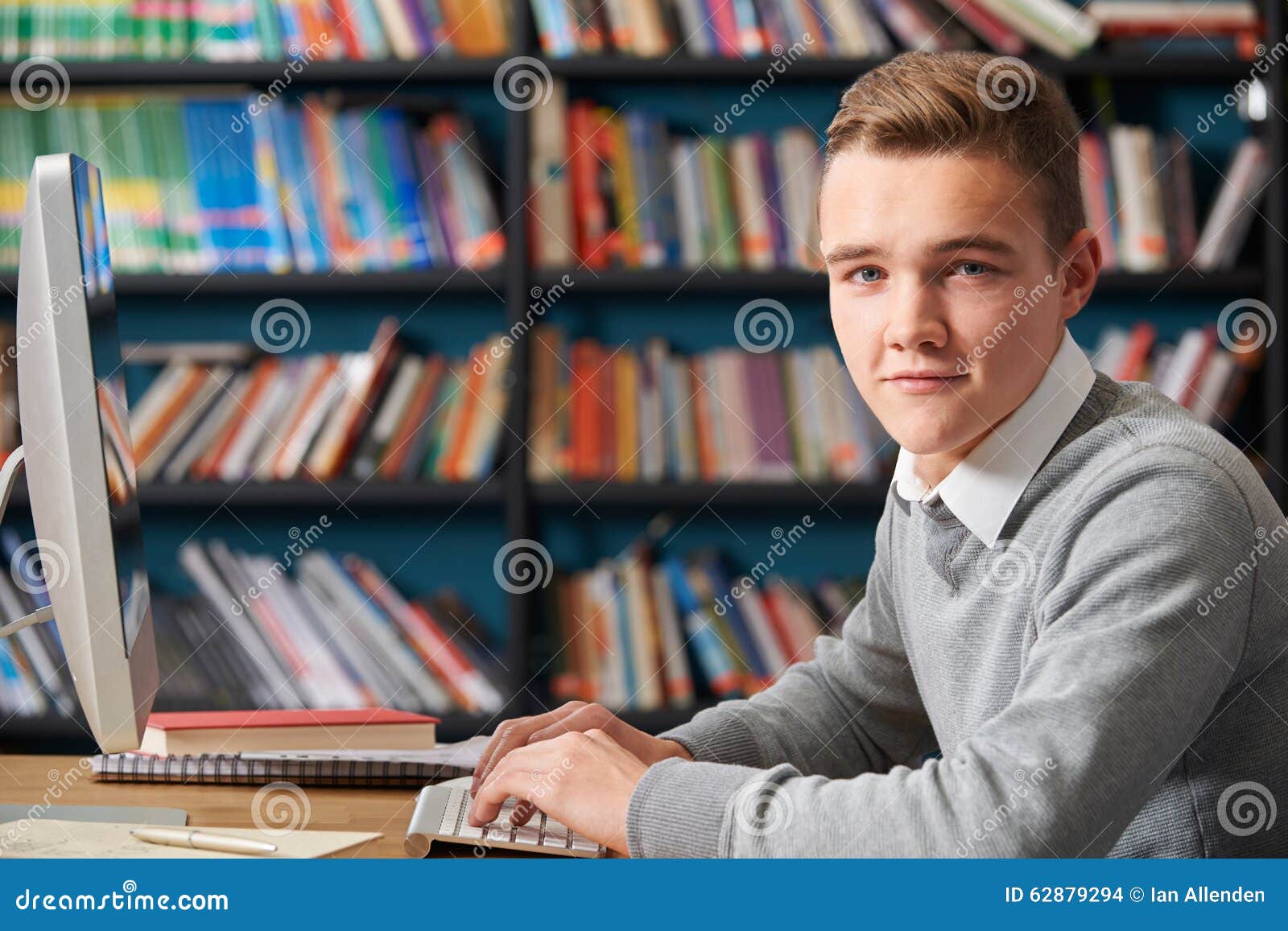 Male Teenage Student Working in Library Stock Photo - Image of people ...