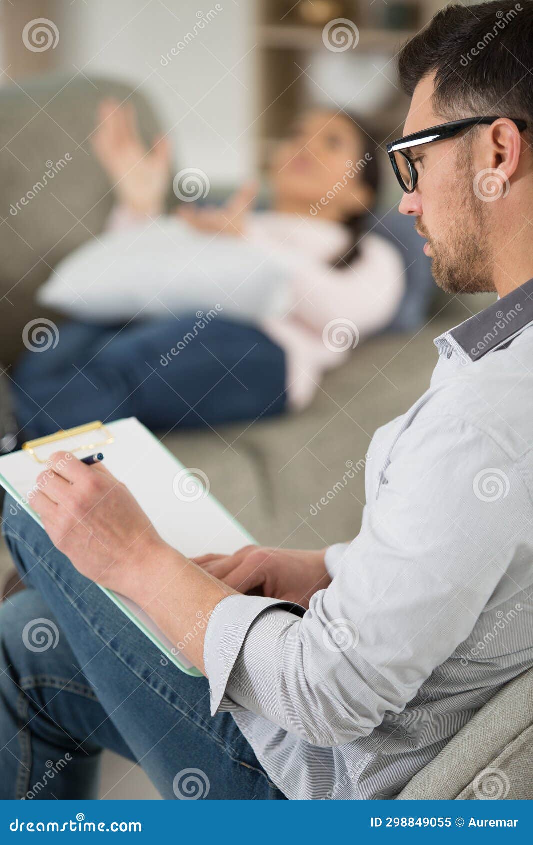 Male Therapist Making Notes on Clipboard Stock Image - Image of ...