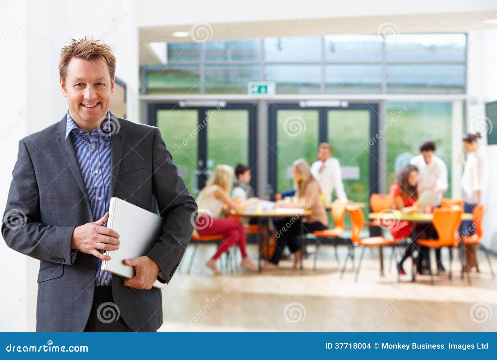Male Tutor Standing In Front Of Whiteboard And Writing Math Equations ...