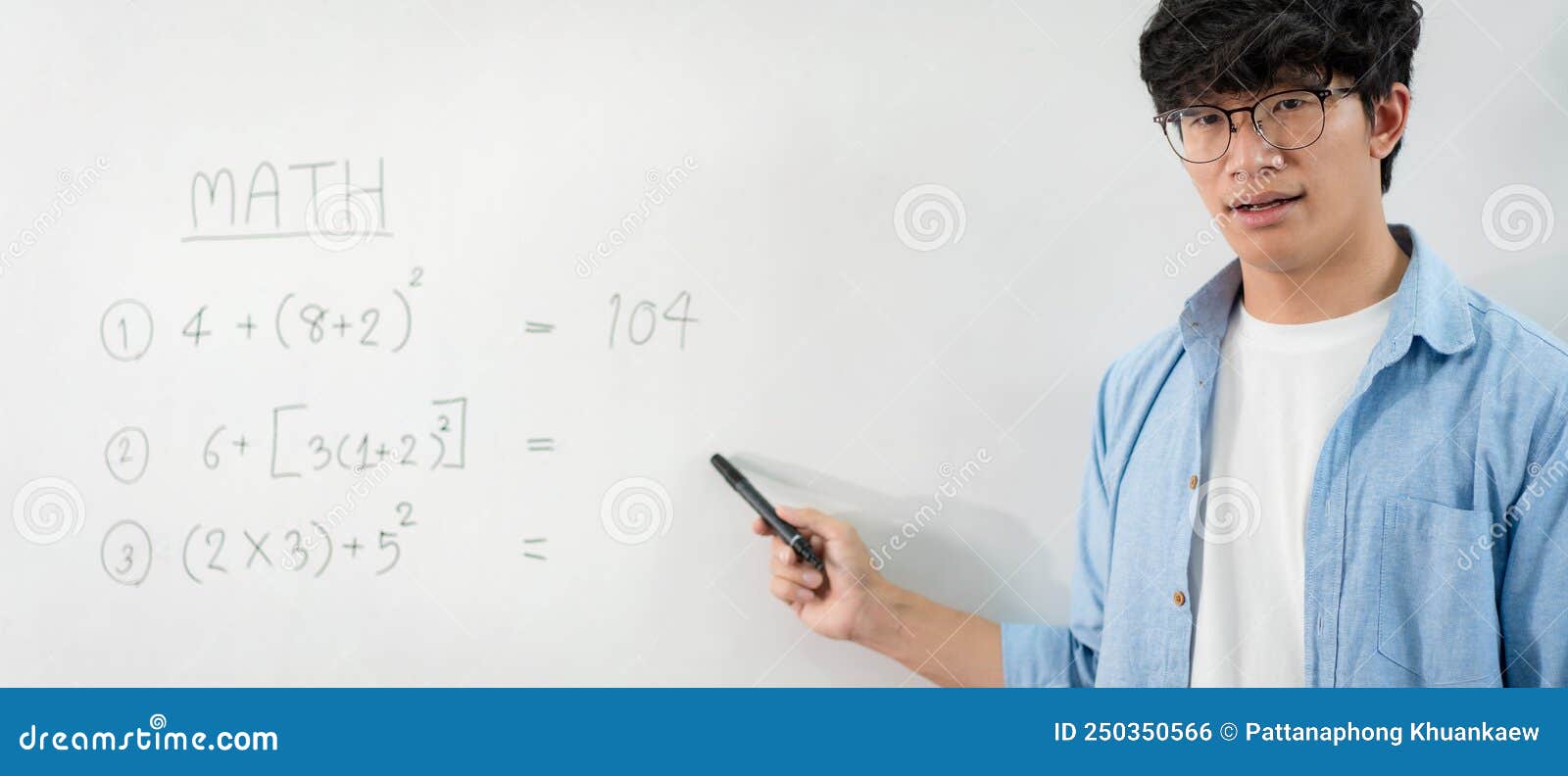 Male Tutor Standing in Front of Whiteboard and Writing Math Equations ...