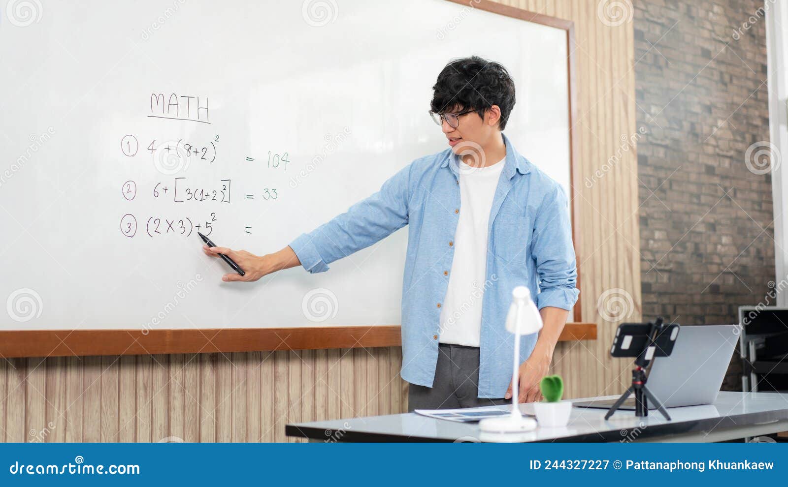 Male Tutor Standing in Front of Whiteboard and Writing Math Equations ...