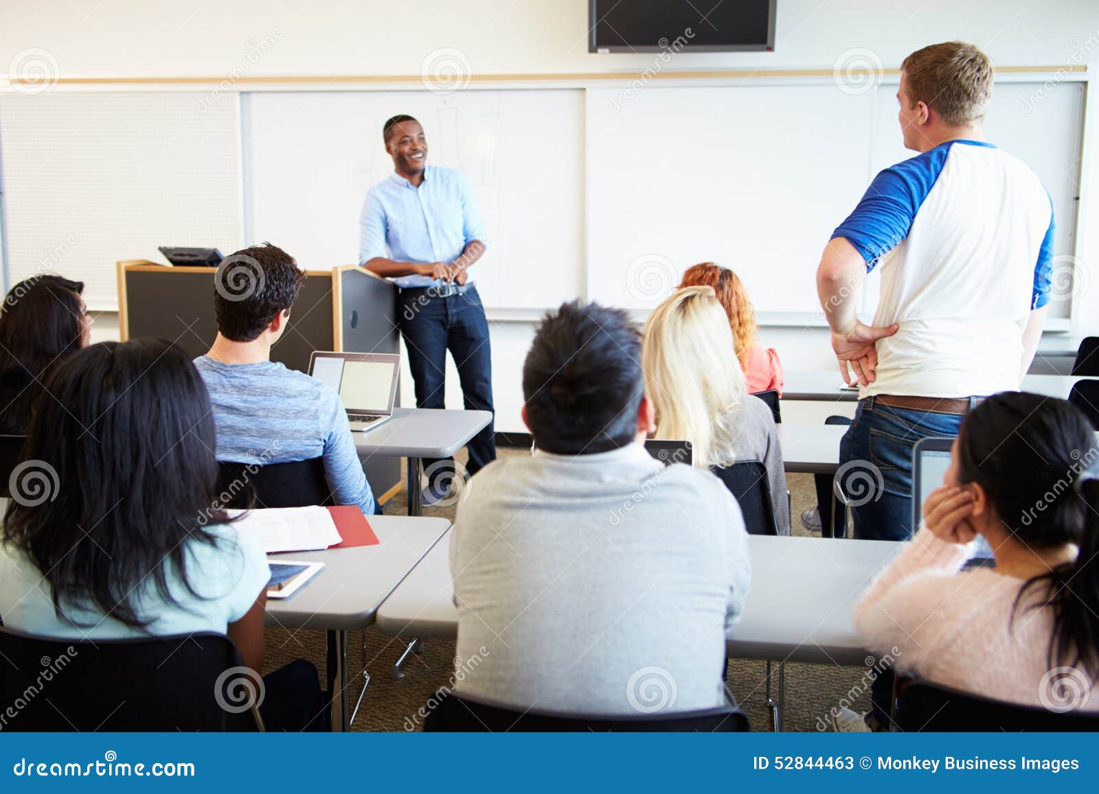 Male Tutor Teaching University Students in Classroom Stock Image ...