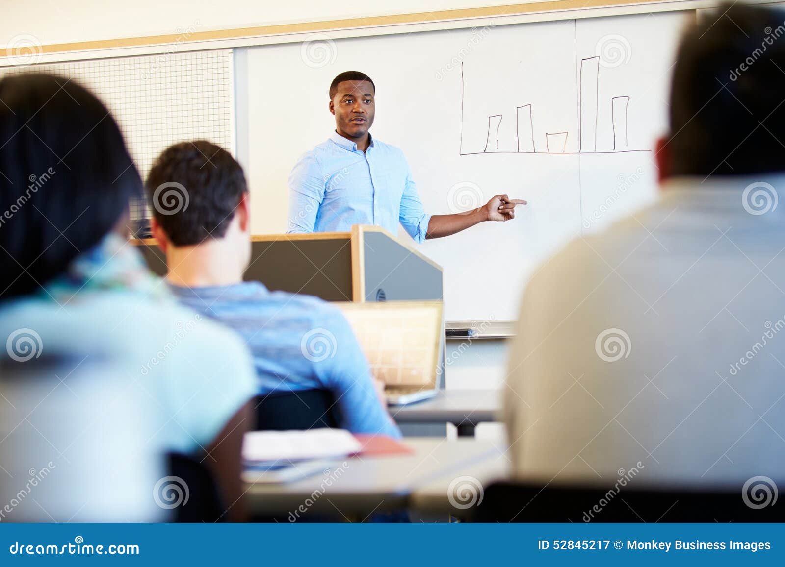 Male Tutor Teaching University Students in Classroom Stock Image ...