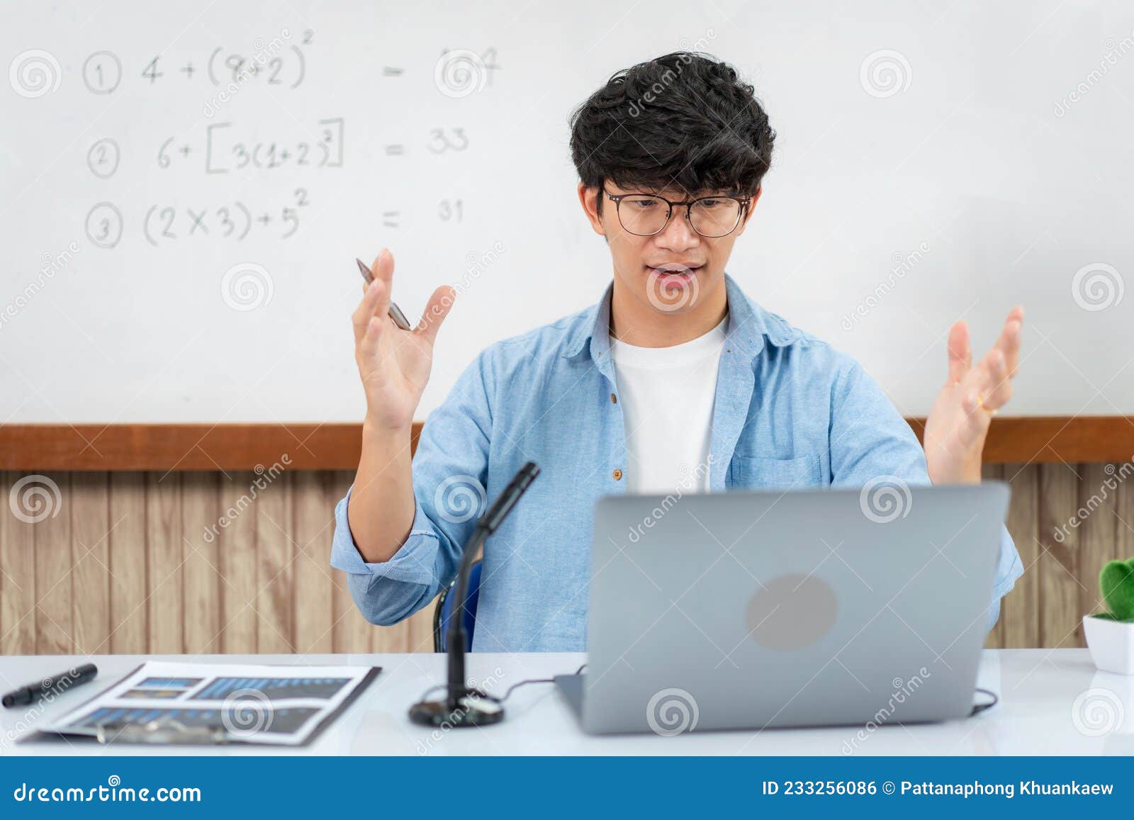 Male Tutor Using Laptop and Though Camera To Teaching New Lesson by ...