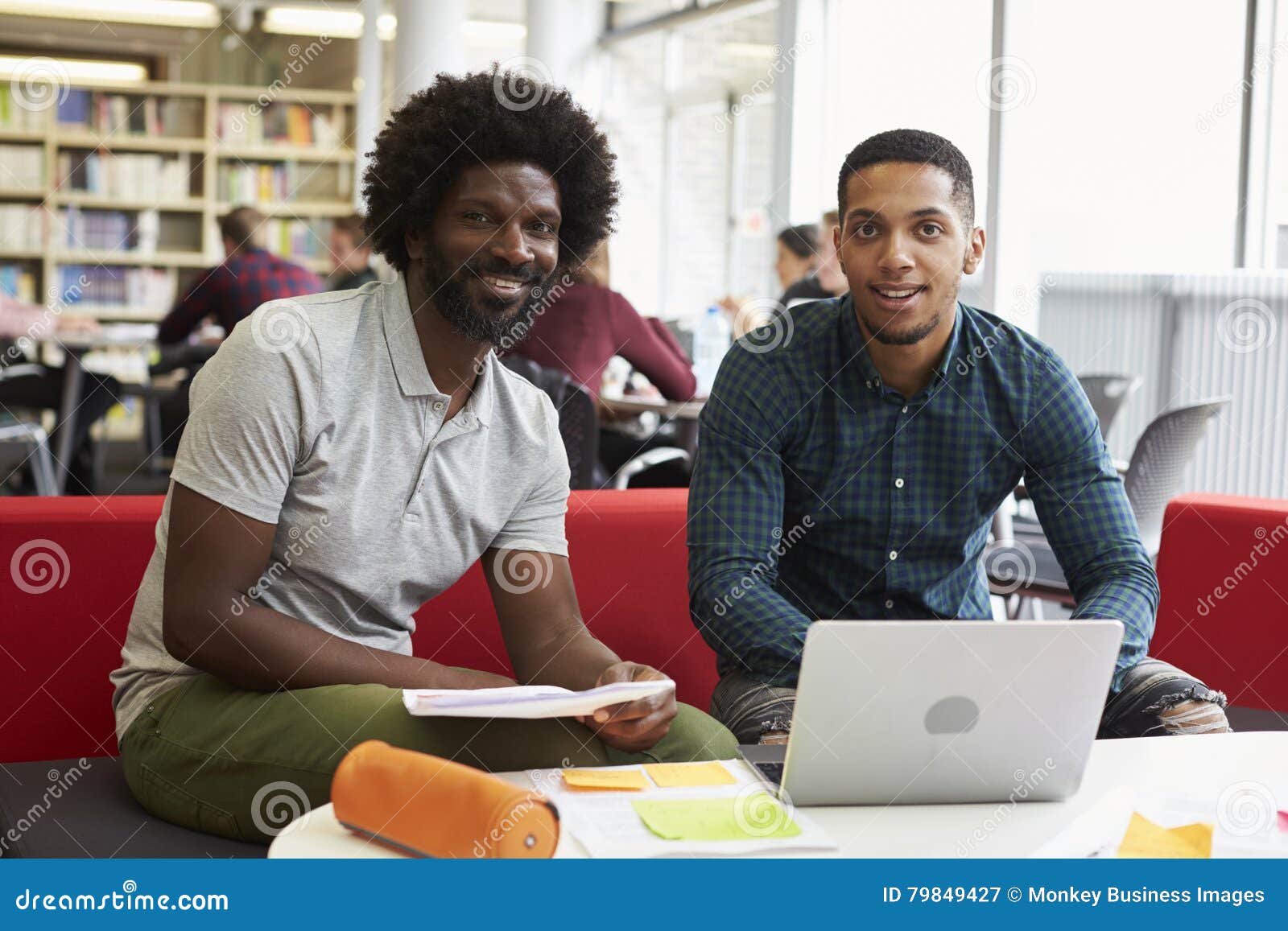 Male University Student Working in Library with Tutor Stock Image ...