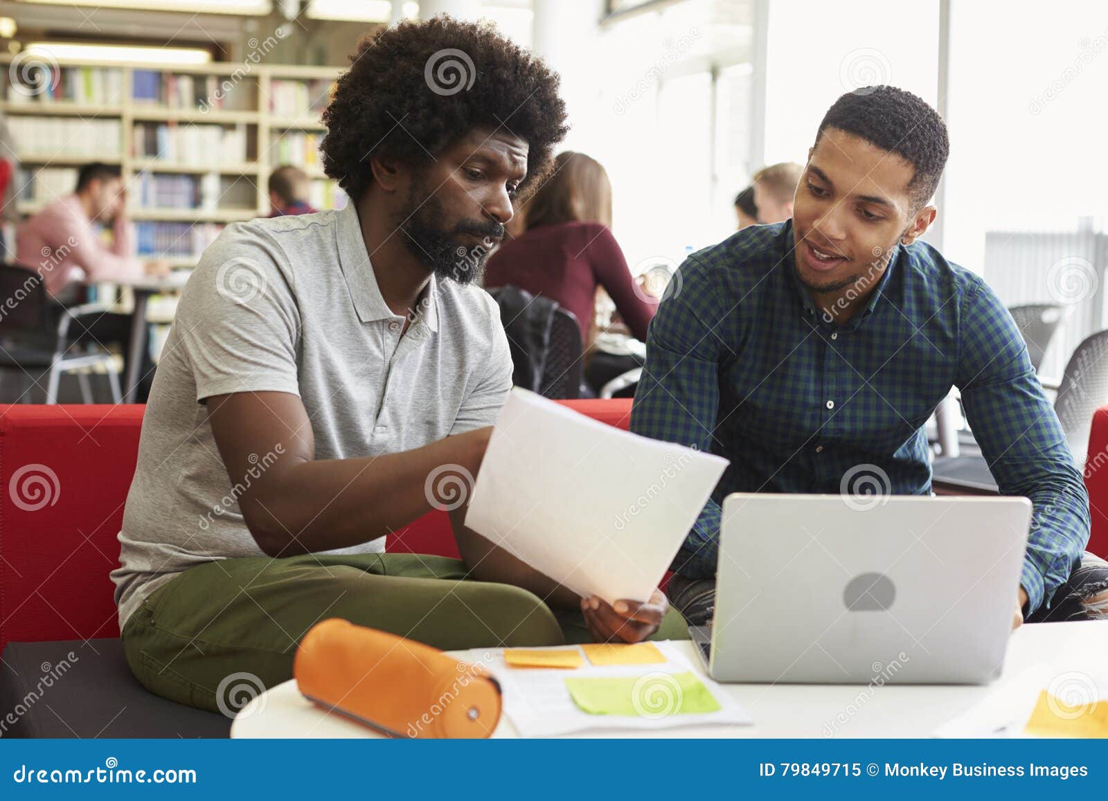 Male University Student Working in Library with Tutor Stock Image ...