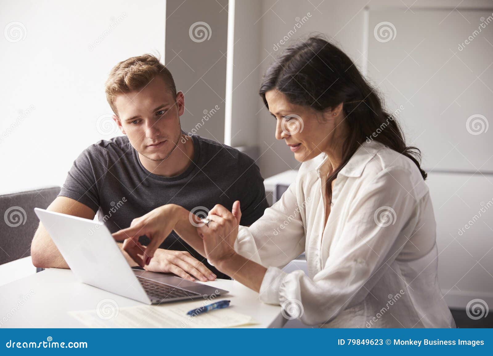 Male University Student Working One To One with Tutor Stock Image ...