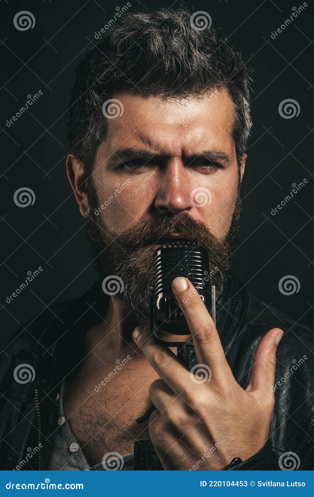 Male Vocalist Singing Into Microphone In Recording Studio. Creating New ... Male Vocalist Singing Into Microphone In Recording Studio. Creating New ...