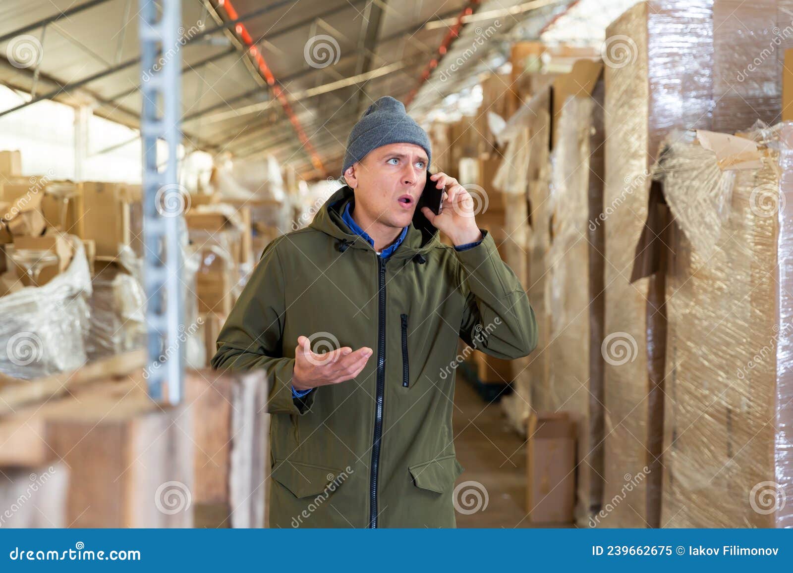 Male Warehouse Worker Talking on Cell Phone Stock Image - Image of ...