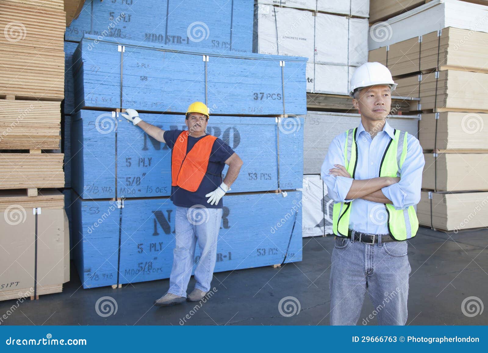 Male Warehouse Workers Standing in Front of Stack of Plywood Stock ...