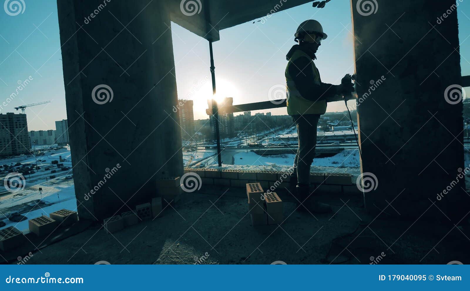 Male Worker is Buffing a Wall of a Multistory Building in Progress ...