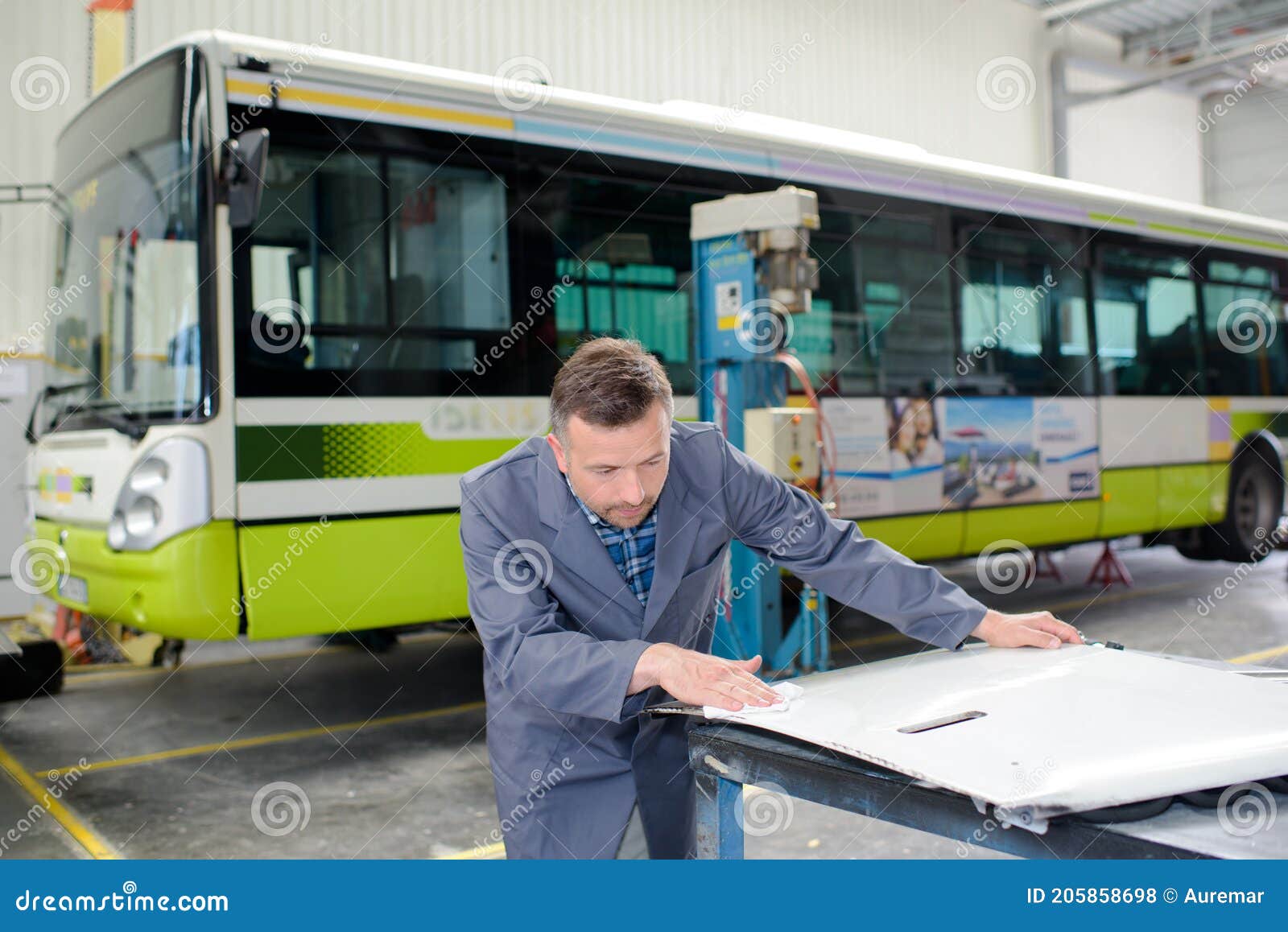 Male worker in bus factory stock photo. Image of regulation - 205858698