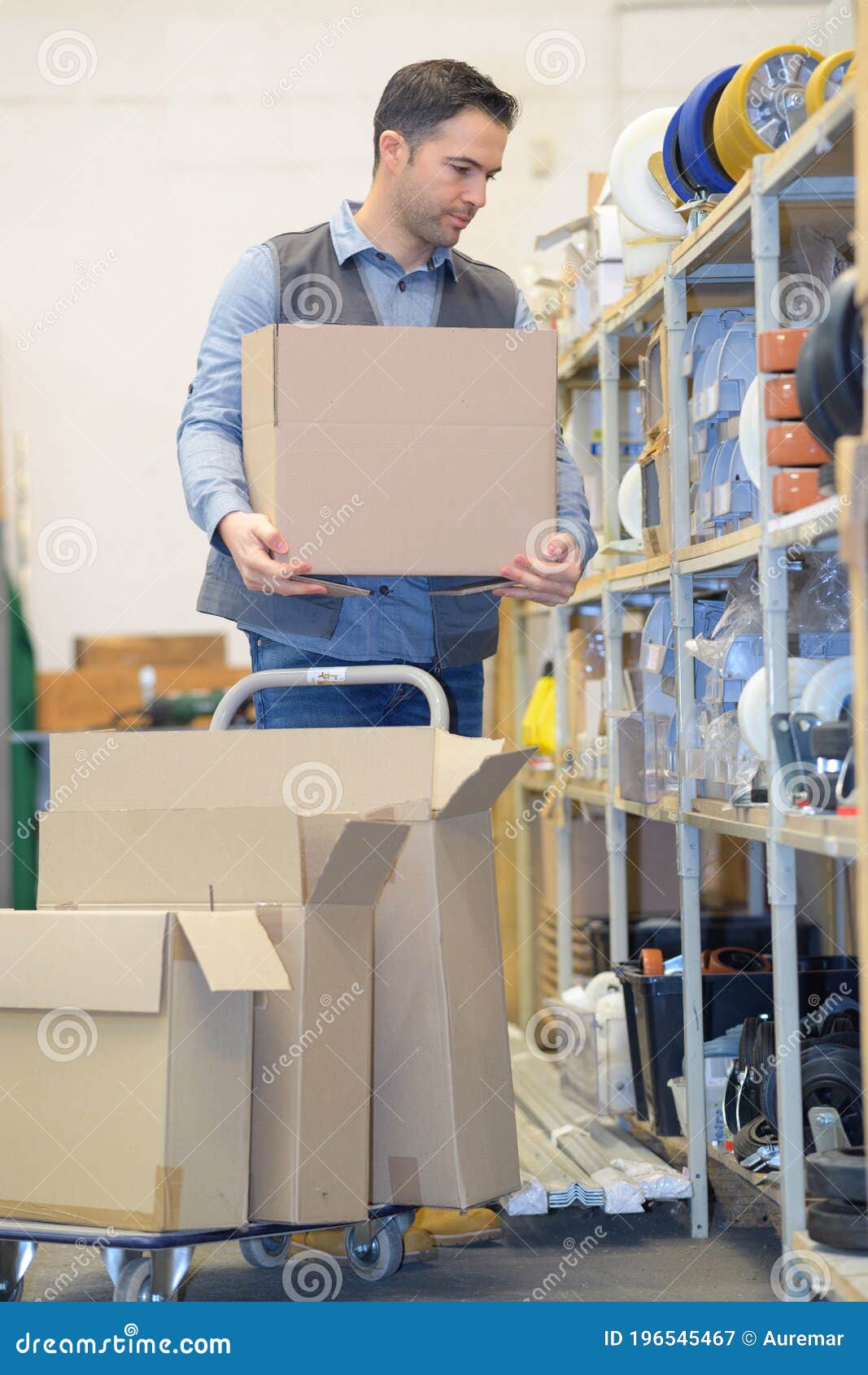 Male Worker with Cardboard Boxes by Storage Racking Stock Image - Image ...