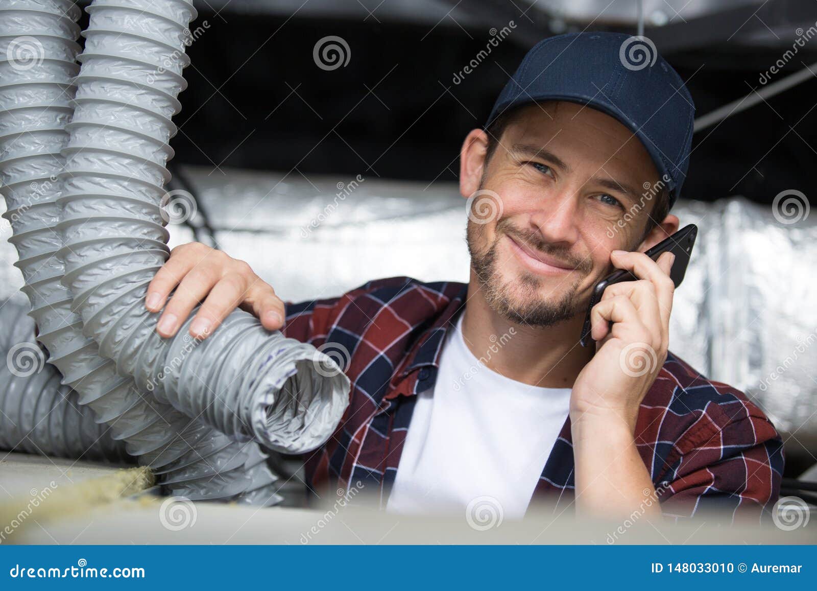 Male Worker Checking Tubes while Using Phone Stock Photo - Image of ...