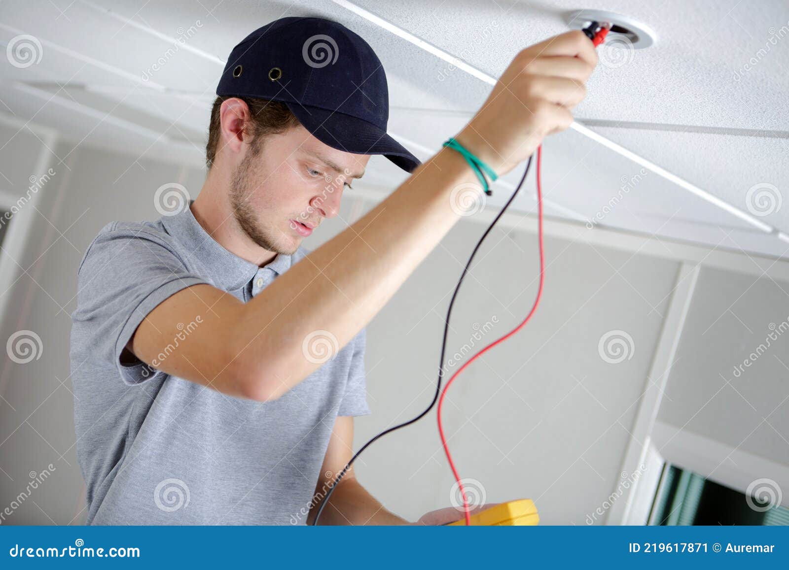 Male worker checking wire stock image. Image of electrical - 219617871