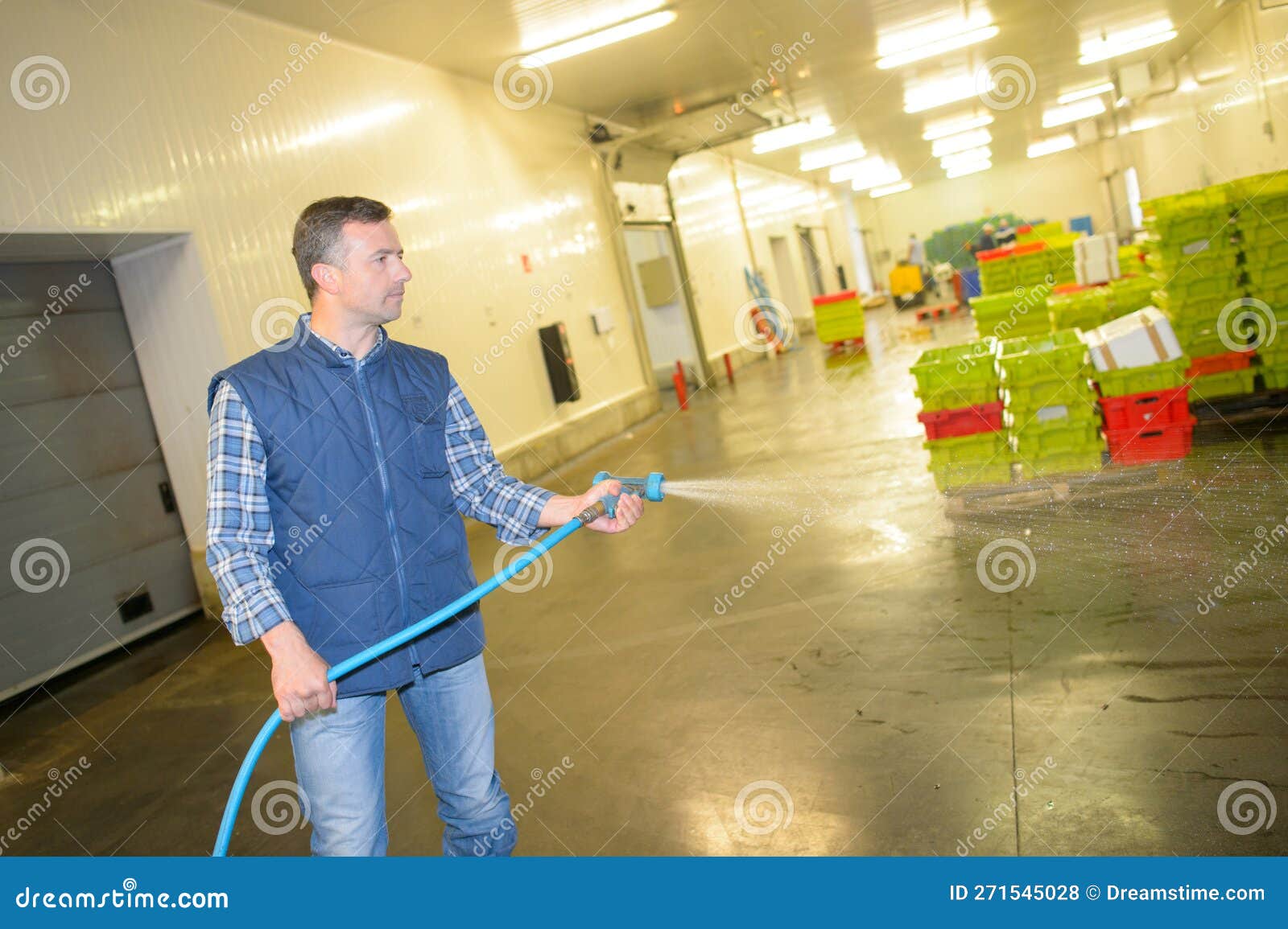 Male worker hosing floor stock photo. Image of clean - 271545028