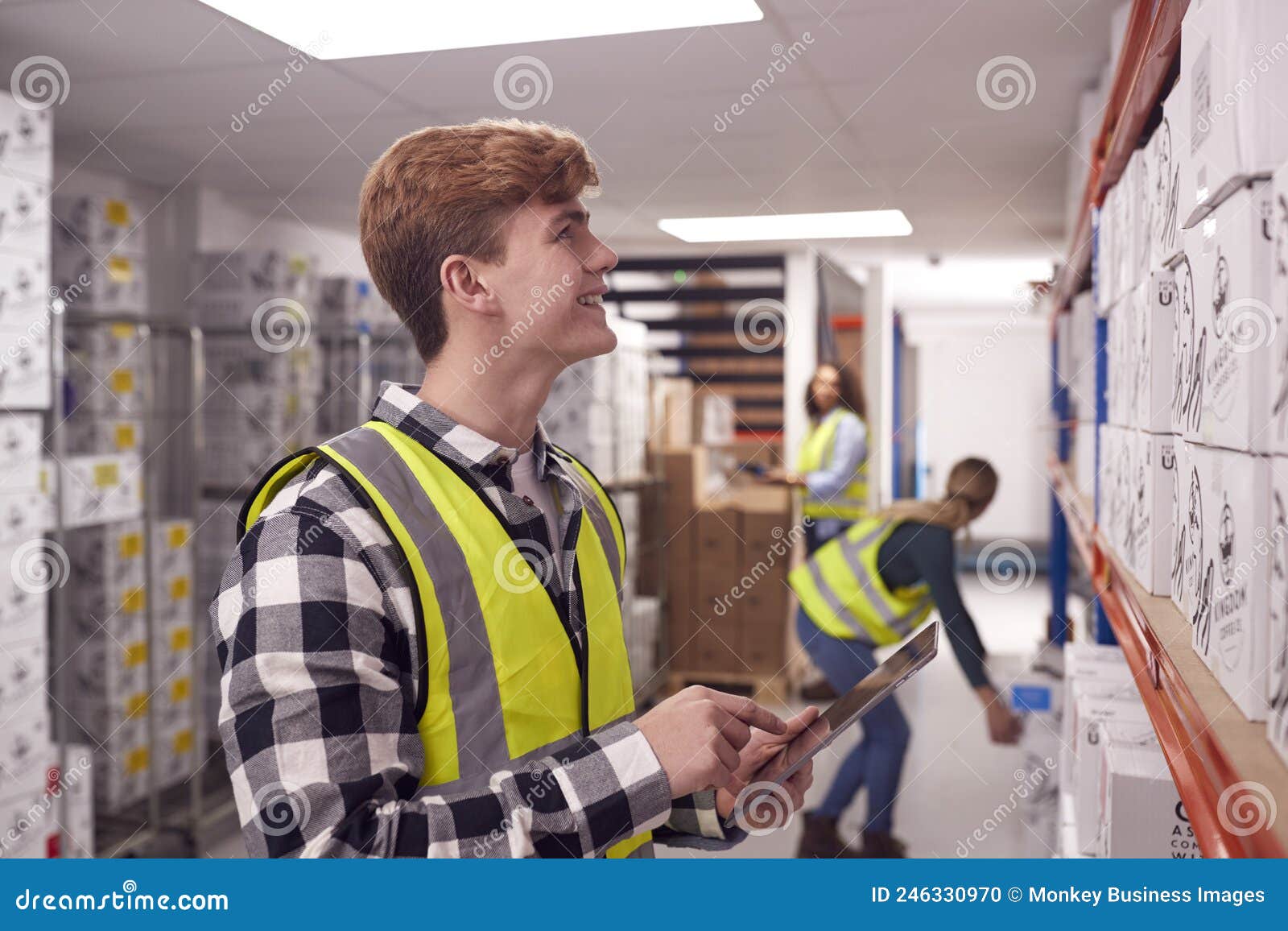 Male Worker Inside Busy Warehouse Checking Stock on Shelves Using ...