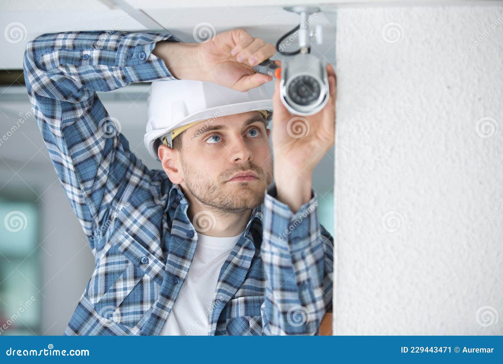 Male Worker Inspecting Security Camera Stock Image - Image of fixing ...