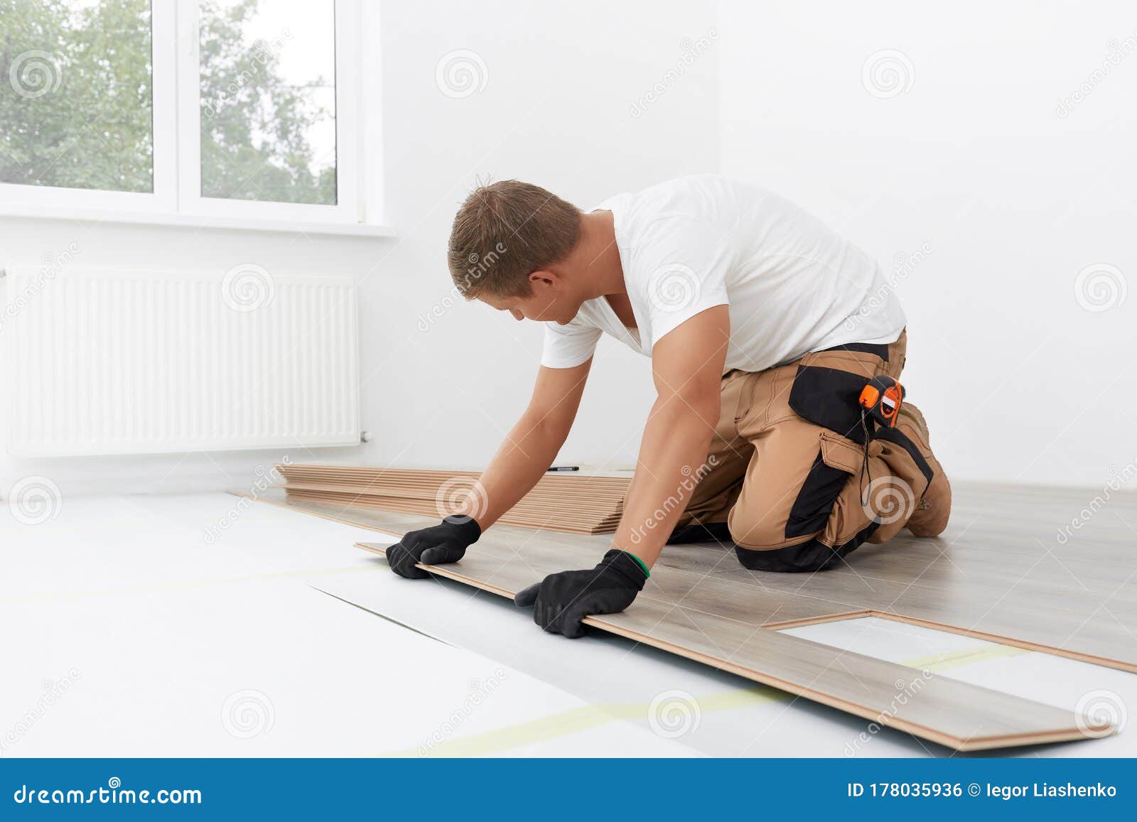 Male Worker Installing Laminate Flooring Stock Photo - Image of parquet ...