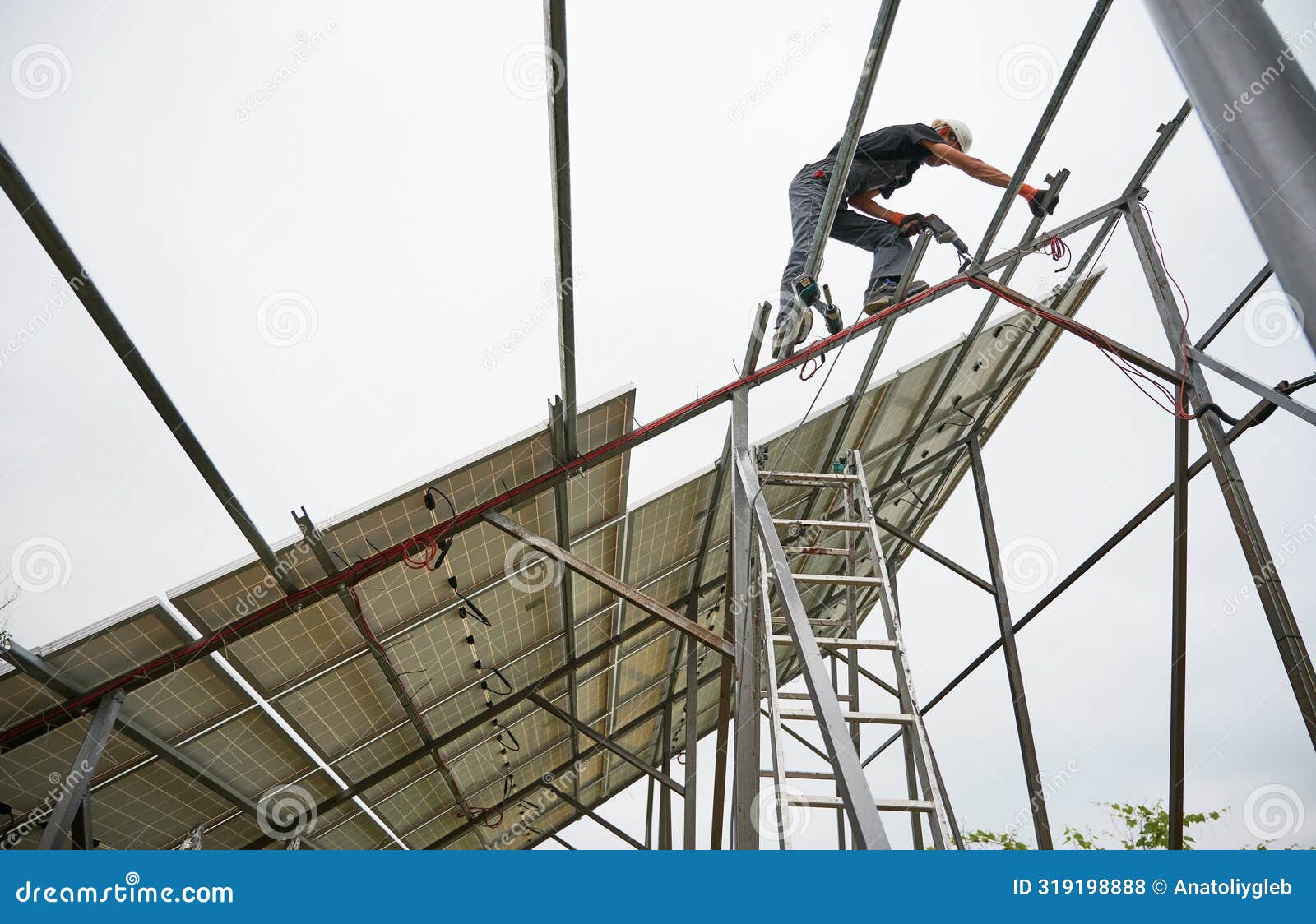 Male Worker Installing Metal Poles and Rails for Solar Panel System ...
