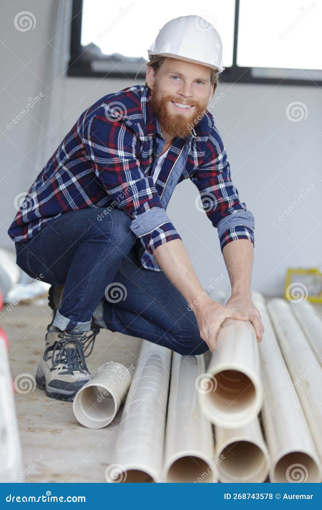 Male Worker Lifting Plastic Pipe Stock Photo - Image of property, beige ...