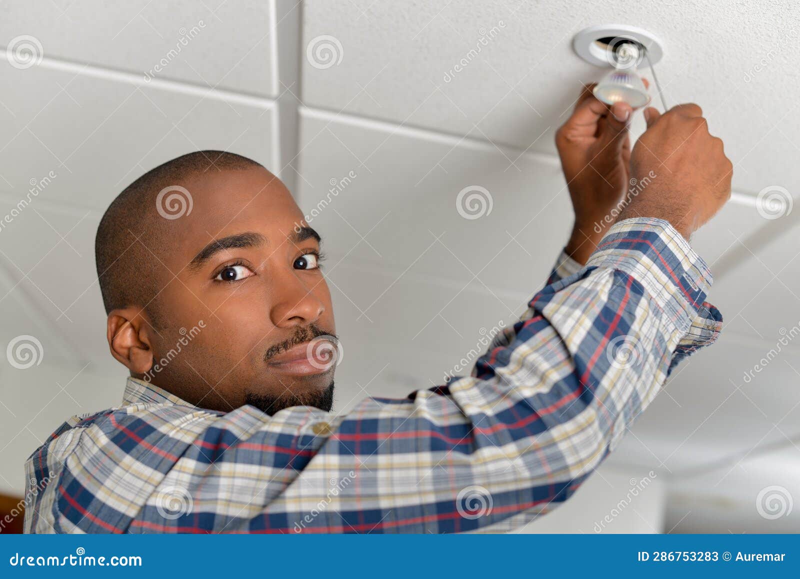 Male Worker Replacing Light Bulb Stock Image - Image of working, home ...