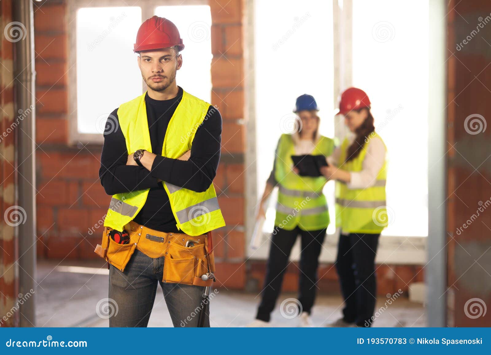 Male Worker on a Residential Construction Site with His Team of ...