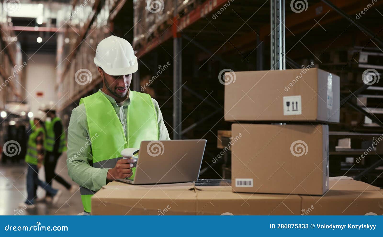 Male Worker Scanning Box with Barcode Scanner Using Laptop at Warehouse ...