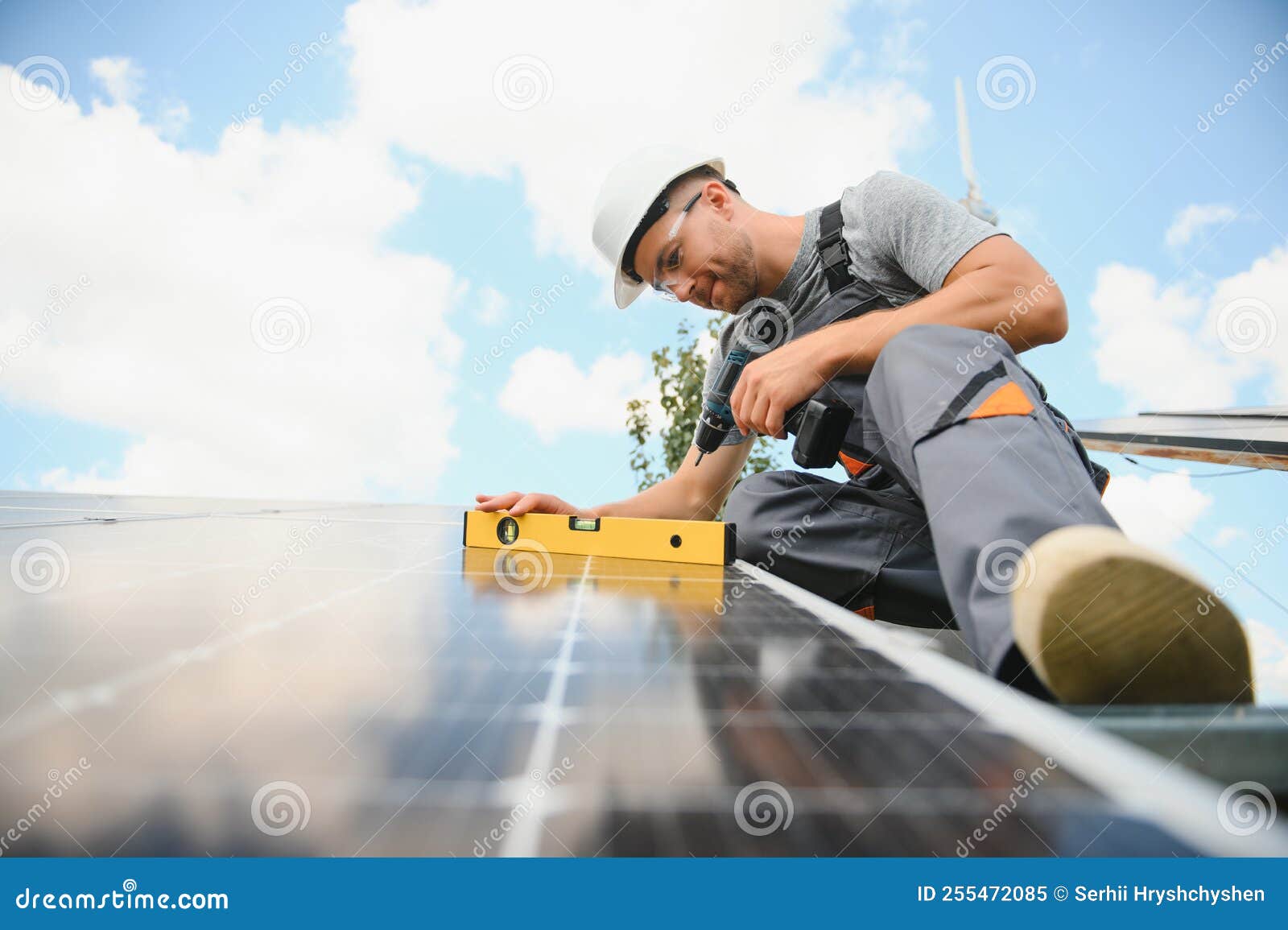Male Worker with Solar Batteries. Man in a Protective Helmet Stock ...