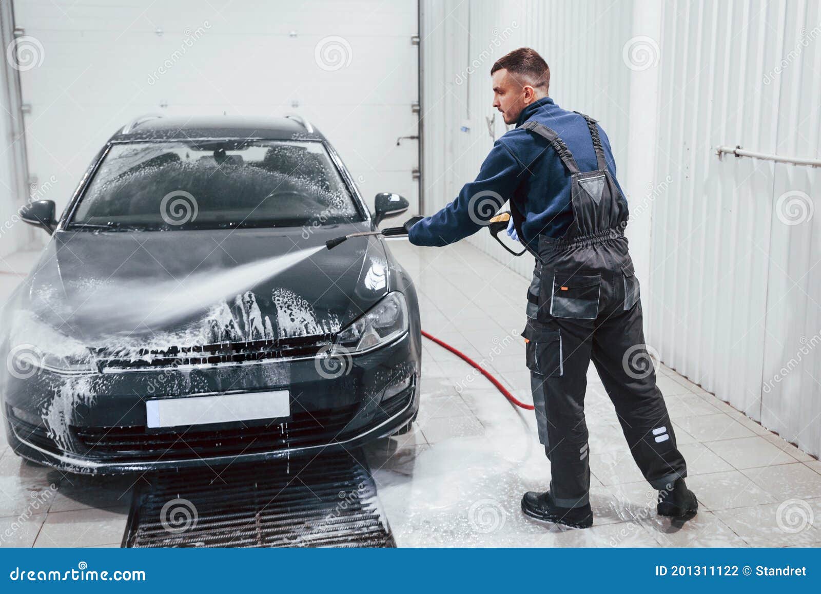 Male Worker in Uniform Washing New Modern Car that Covered with Soap ...