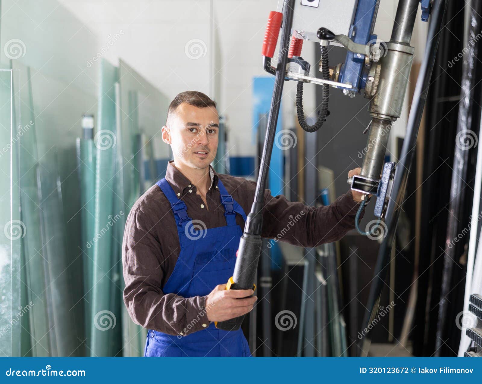 Male Worker Using Control Panel and Lifting Mechanism Controls Movement ...
