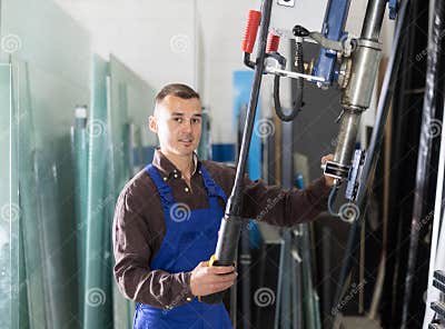 Male Worker Using Control Panel and Lifting Mechanism Controls Movement ...