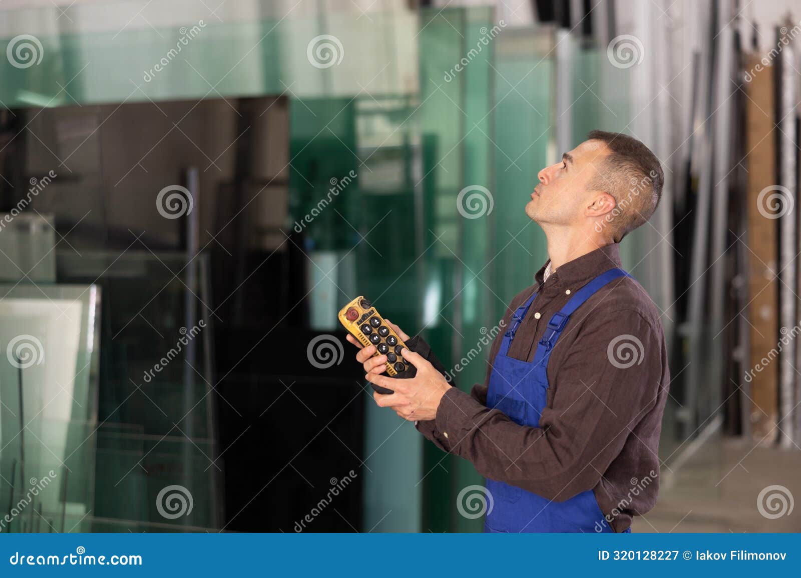 Male Worker Using Control Panel and Lifting Mechanism Controls Movement ...