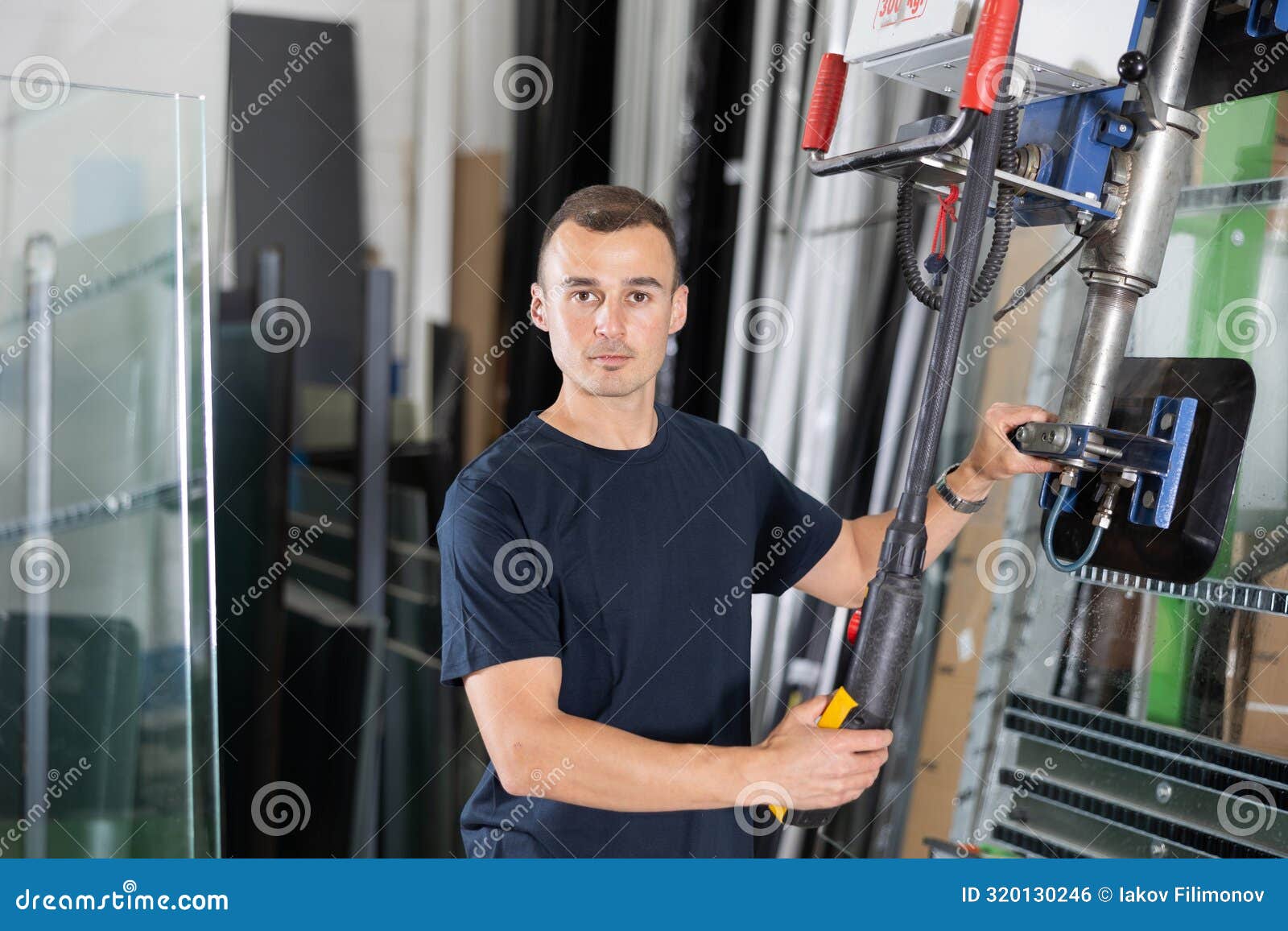 Male Worker Using Control Panel and Lifting Mechanism Controls Movement ...