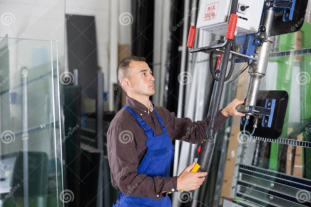 Male Worker Using Control Panel and Lifting Mechanism Controls Movement ...