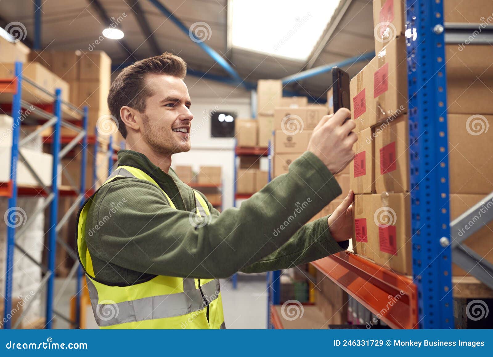 Male Worker Wearing Inside Warehouse Scanning Stock Barcode on Shelves ...