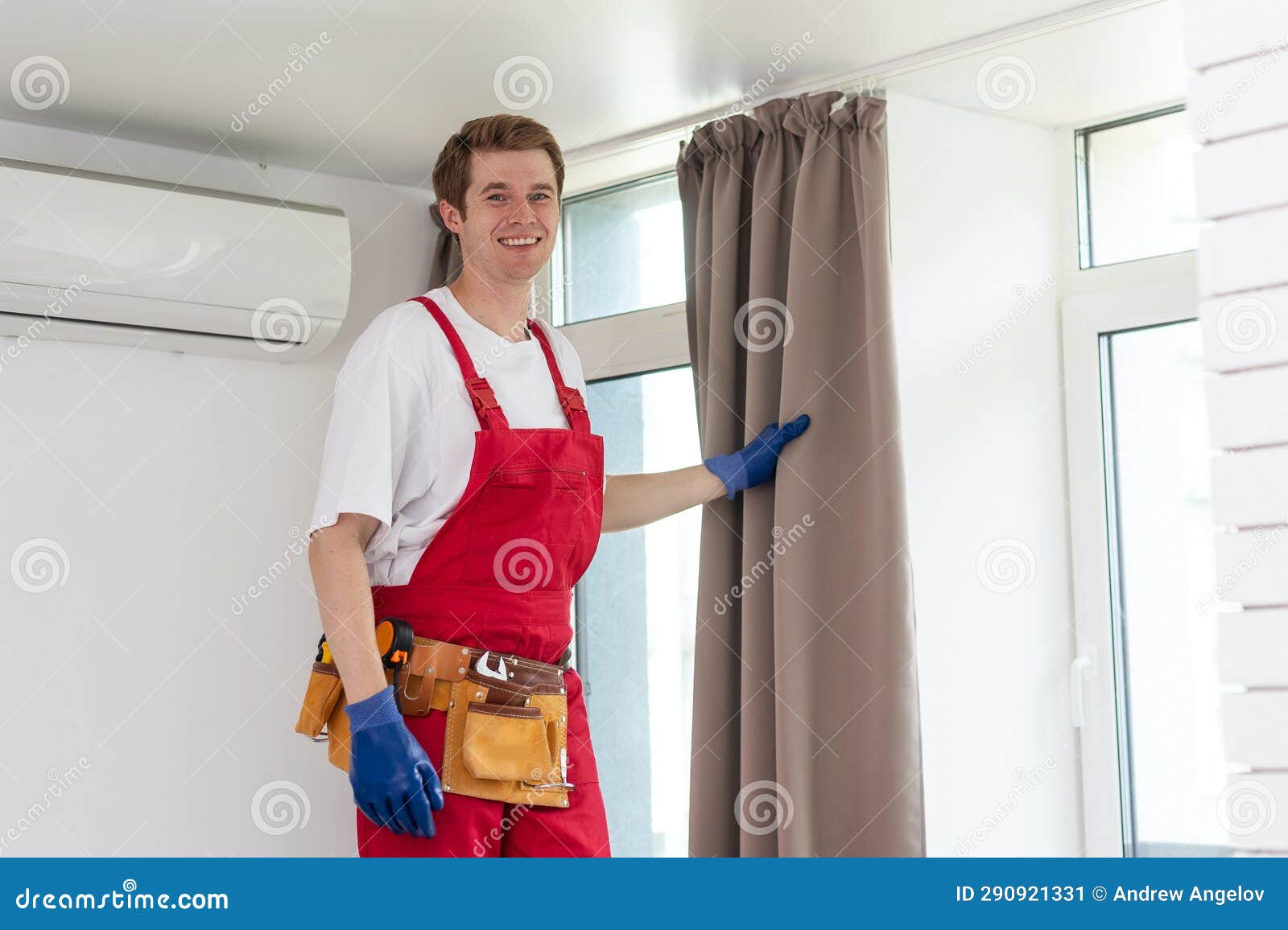 A Male Worker Who Installs a Curtain. Stock Image - Image of installing ...