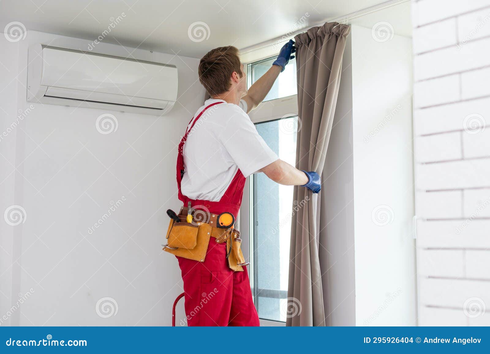 A Male Worker Who Installs a Curtain. Stock Photo - Image of protect ...