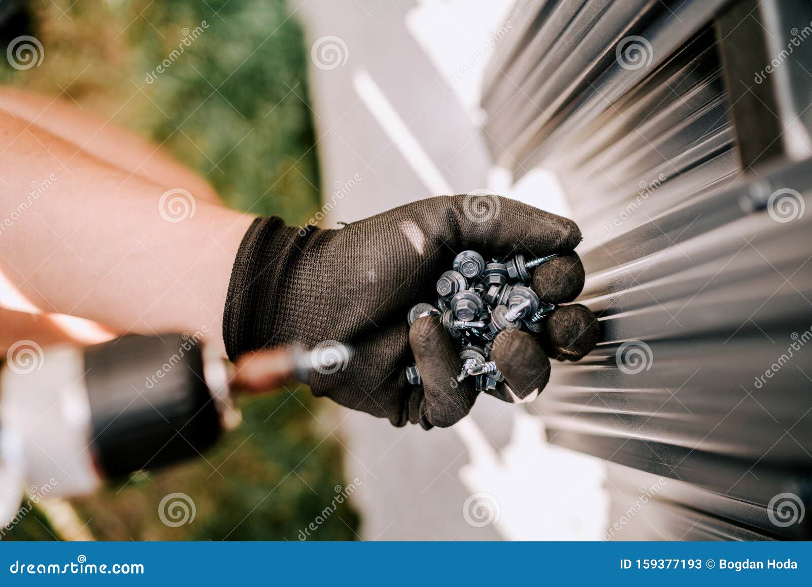 Male Worker Working Screws and Electric Screwdriver on the Construction ...