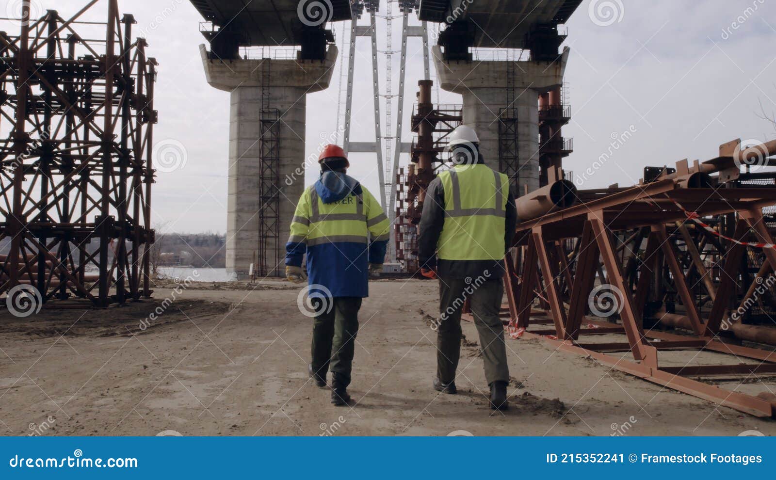 Male Workers Walking and Discussing Bridge Construction Stock Image ...