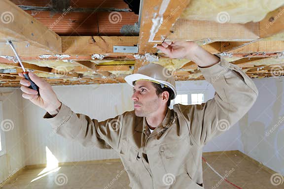 Male working on ceiling stock photo. Image of skill - 245861764