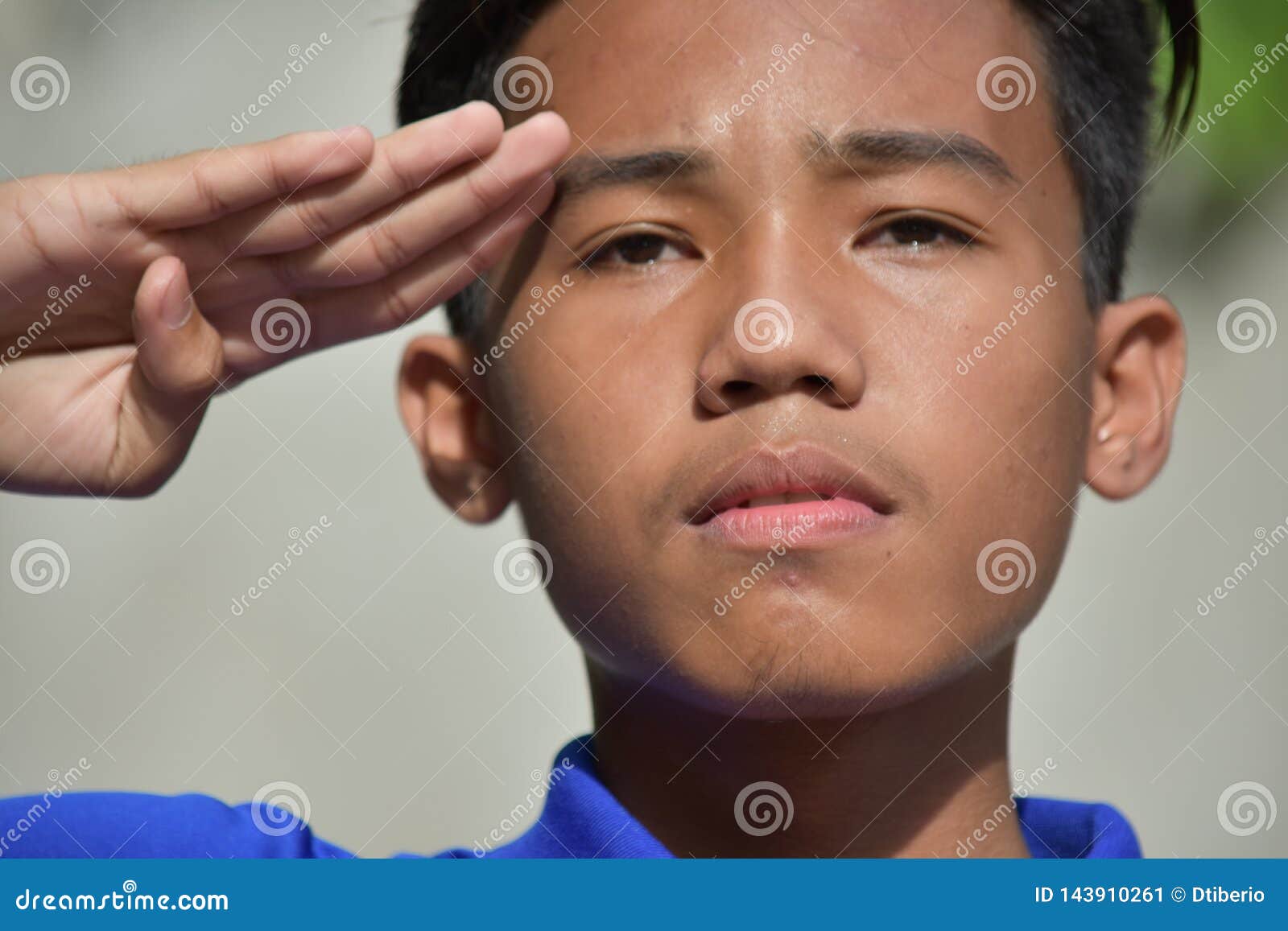 A Male Youngster Saluting stock image. Image of salute - 143910261