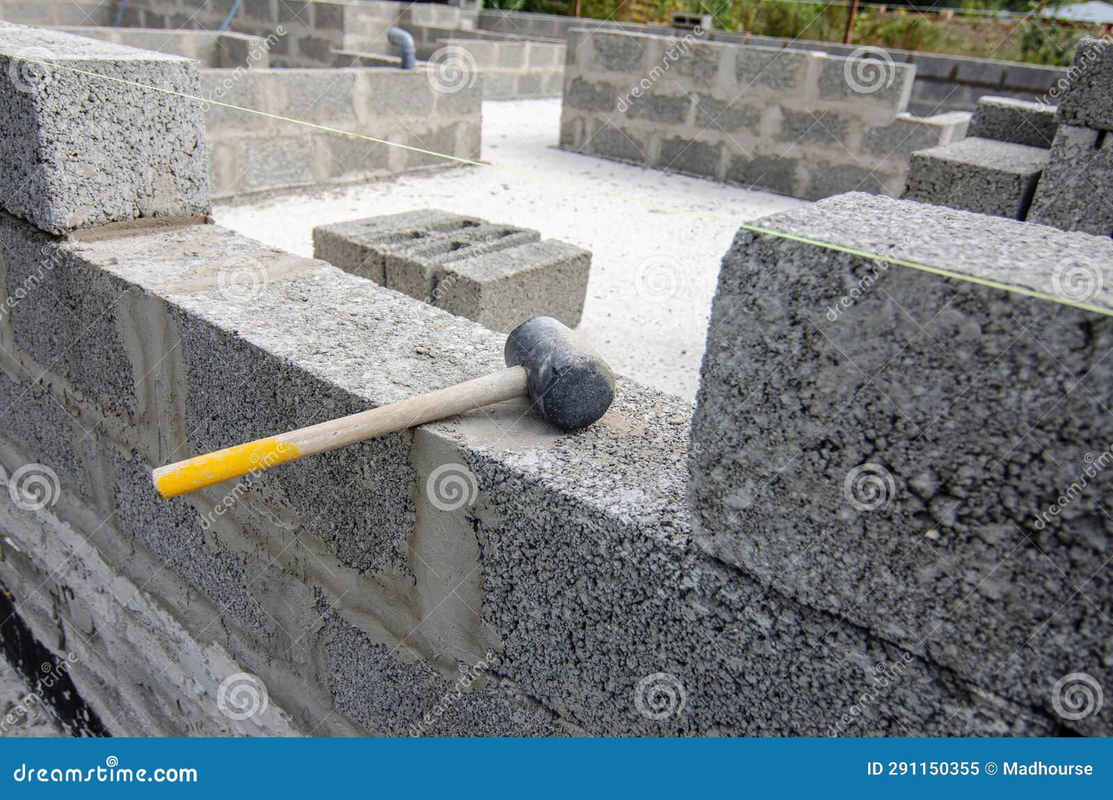 A Mallet Lies on a Part of a Wall Made of Expanded Clay Concrete Blocks ...